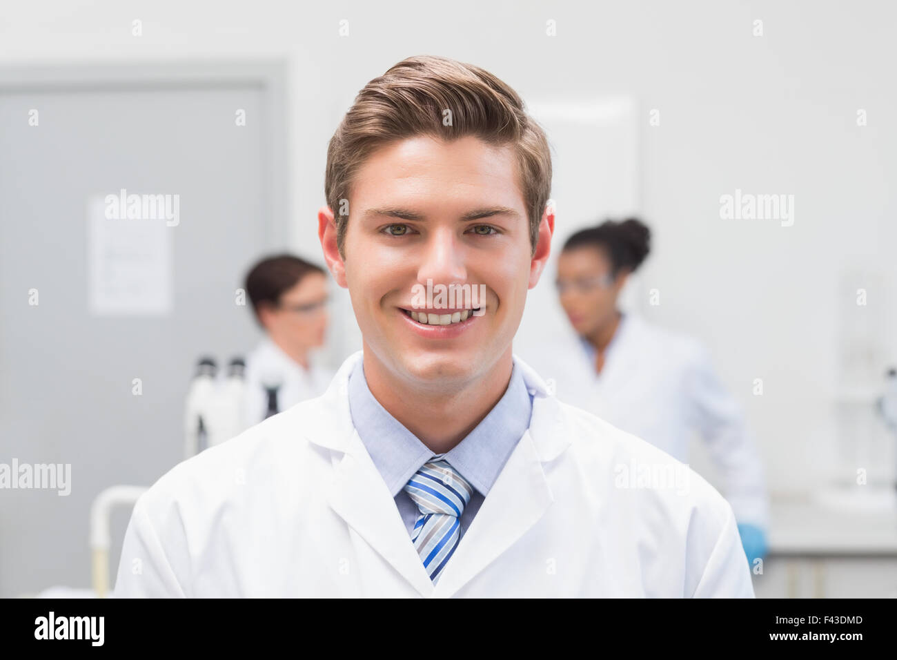 Happy scientist smiling at camera Stock Photo - Alamy