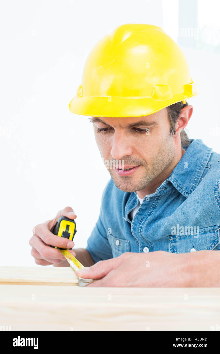 Carpenter measuring wood plank Stock Photo - Alamy