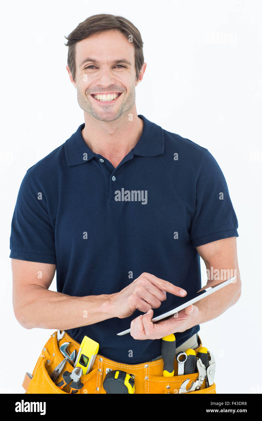 Happy handyman using digital table Stock Photo - Alamy