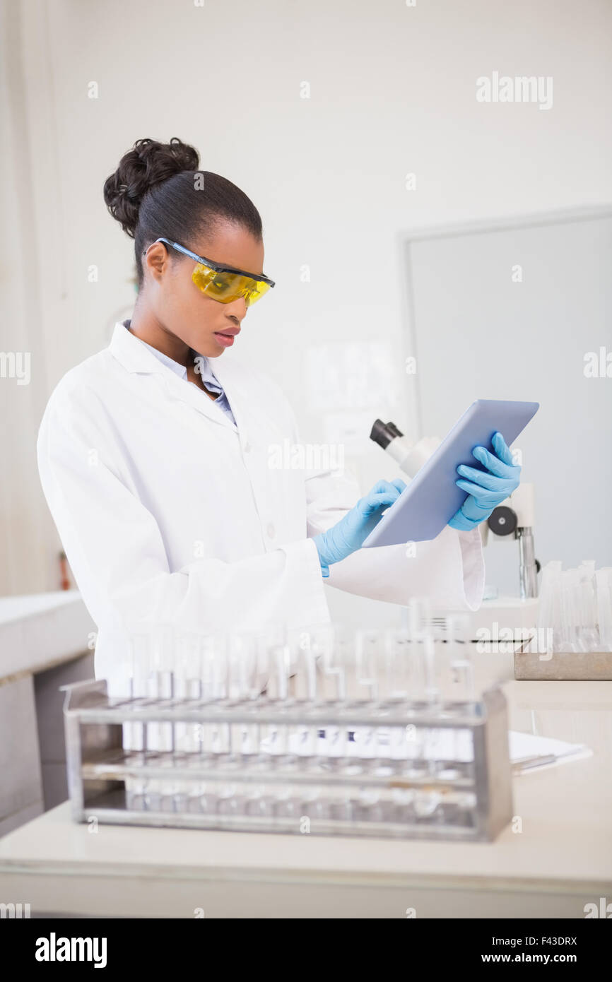 Concentrated scientist working with tablet Stock Photo - Alamy