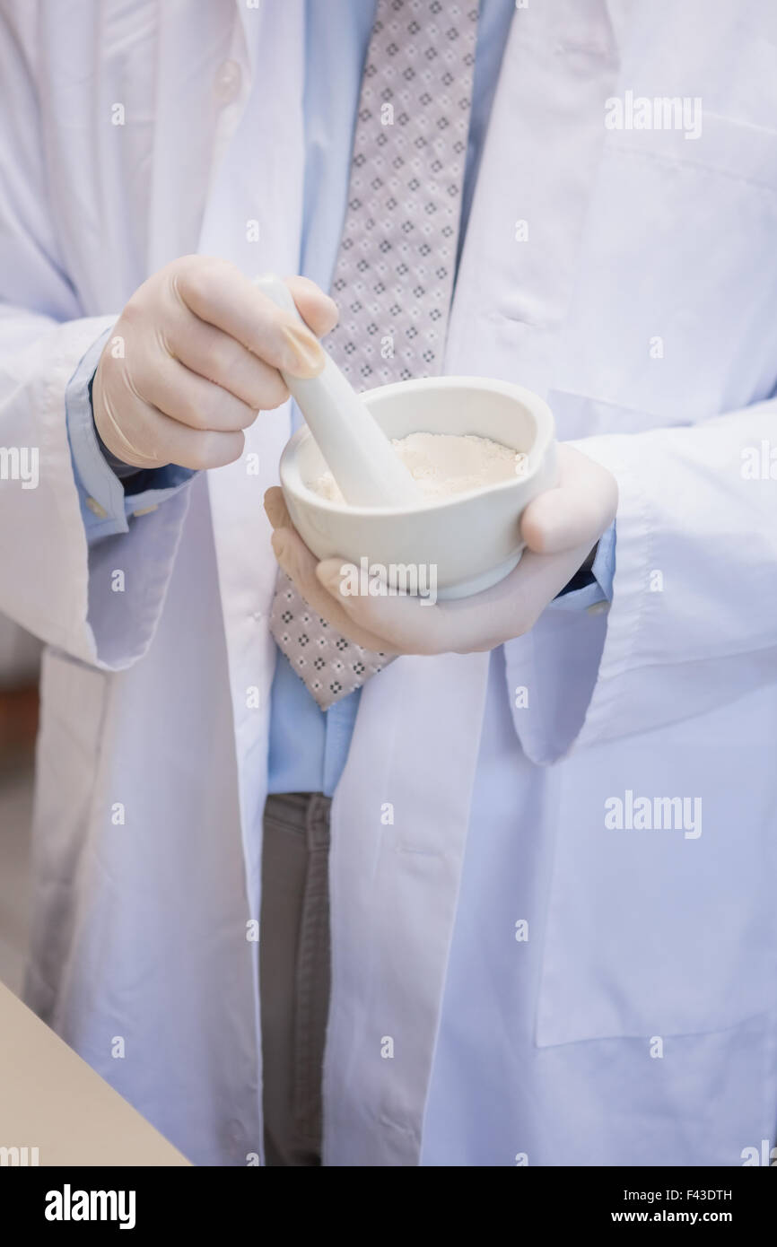 Scientist grinding powder with mortar Stock Photo - Alamy