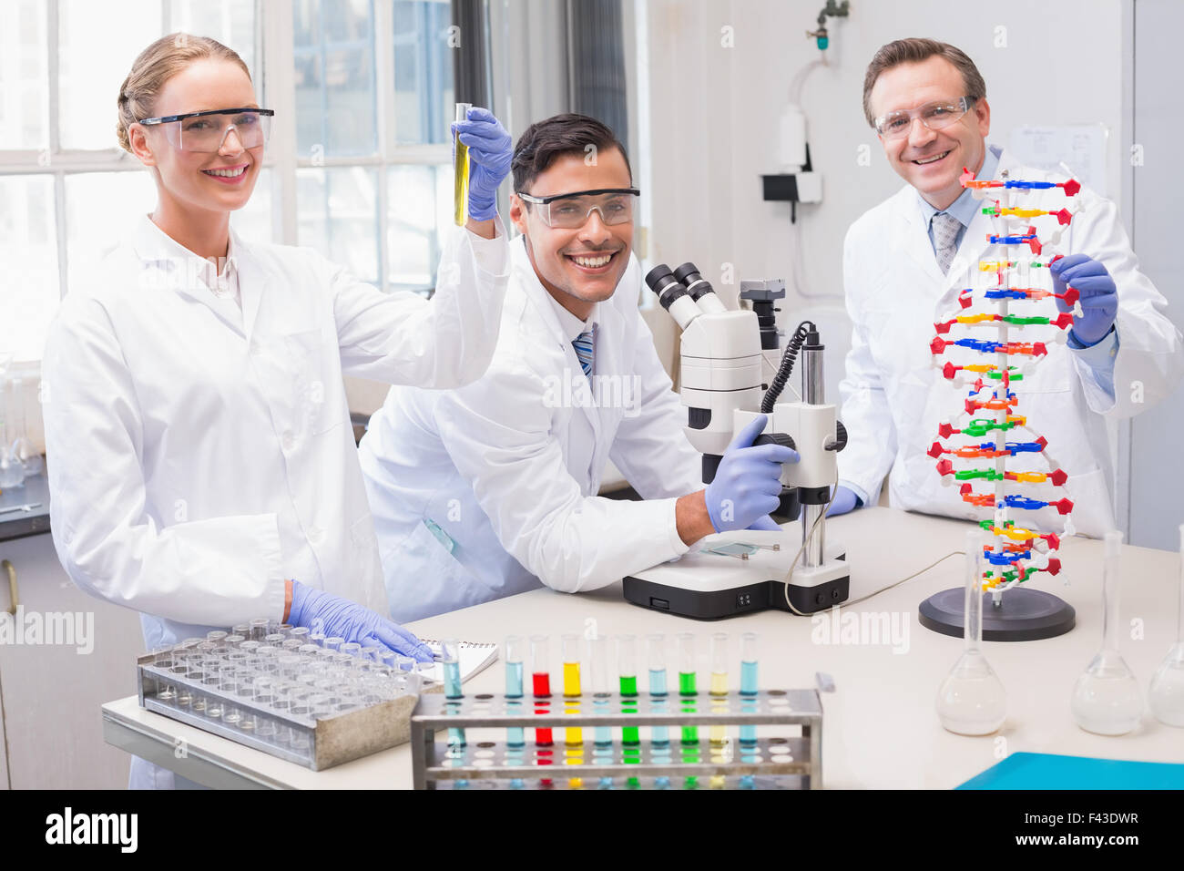 Smiling scientists looking at camera Stock Photo - Alamy