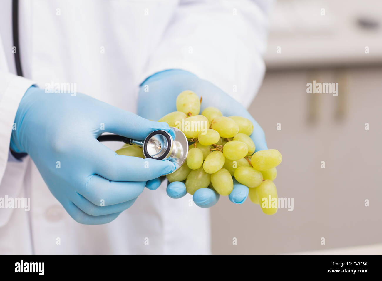Scientist listening grapes with stethoscope Stock Photo - Alamy