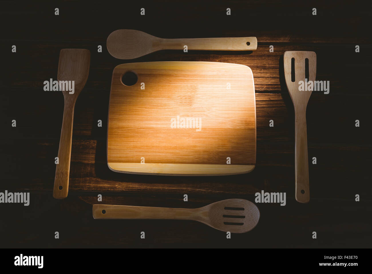 Chopping board with wooden utensils Stock Photo - Alamy