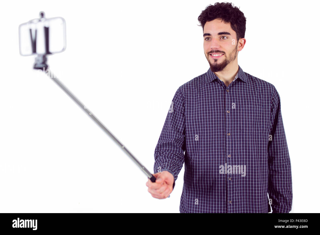 Casual man using a selfie stick Stock Photo - Alamy