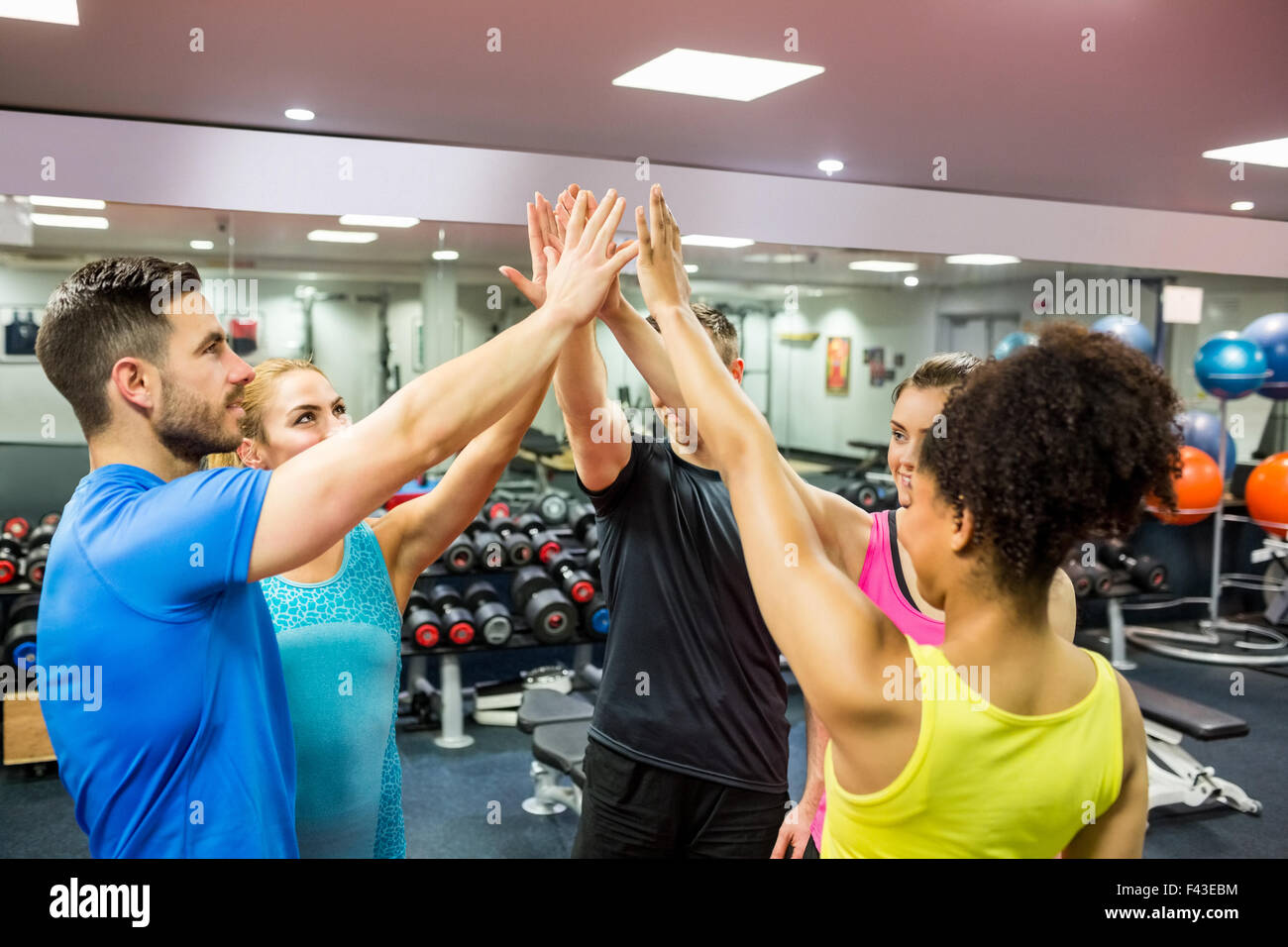 Fit people putting their hands together Stock Photo - Alamy