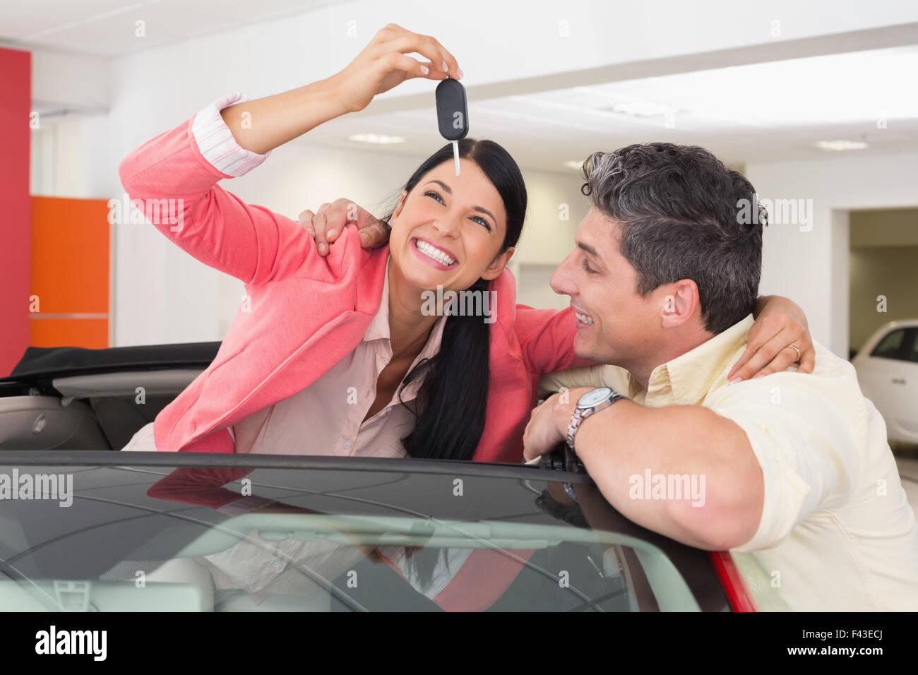 Smiling couple buying a new car Stock Photo - Alamy