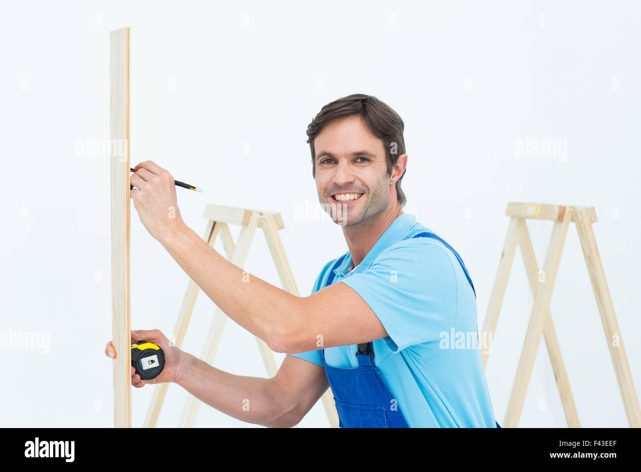 Portrait of carpenter marking on wood Stock Photo - Alamy