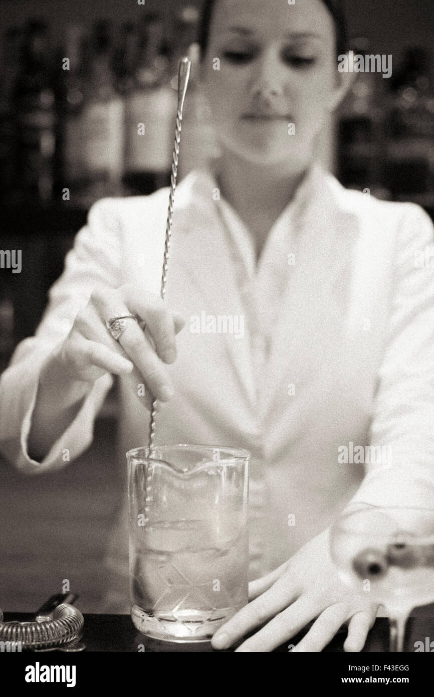 A young woman mixing a cocktail, a mixologist at work Stock Photo - Alamy