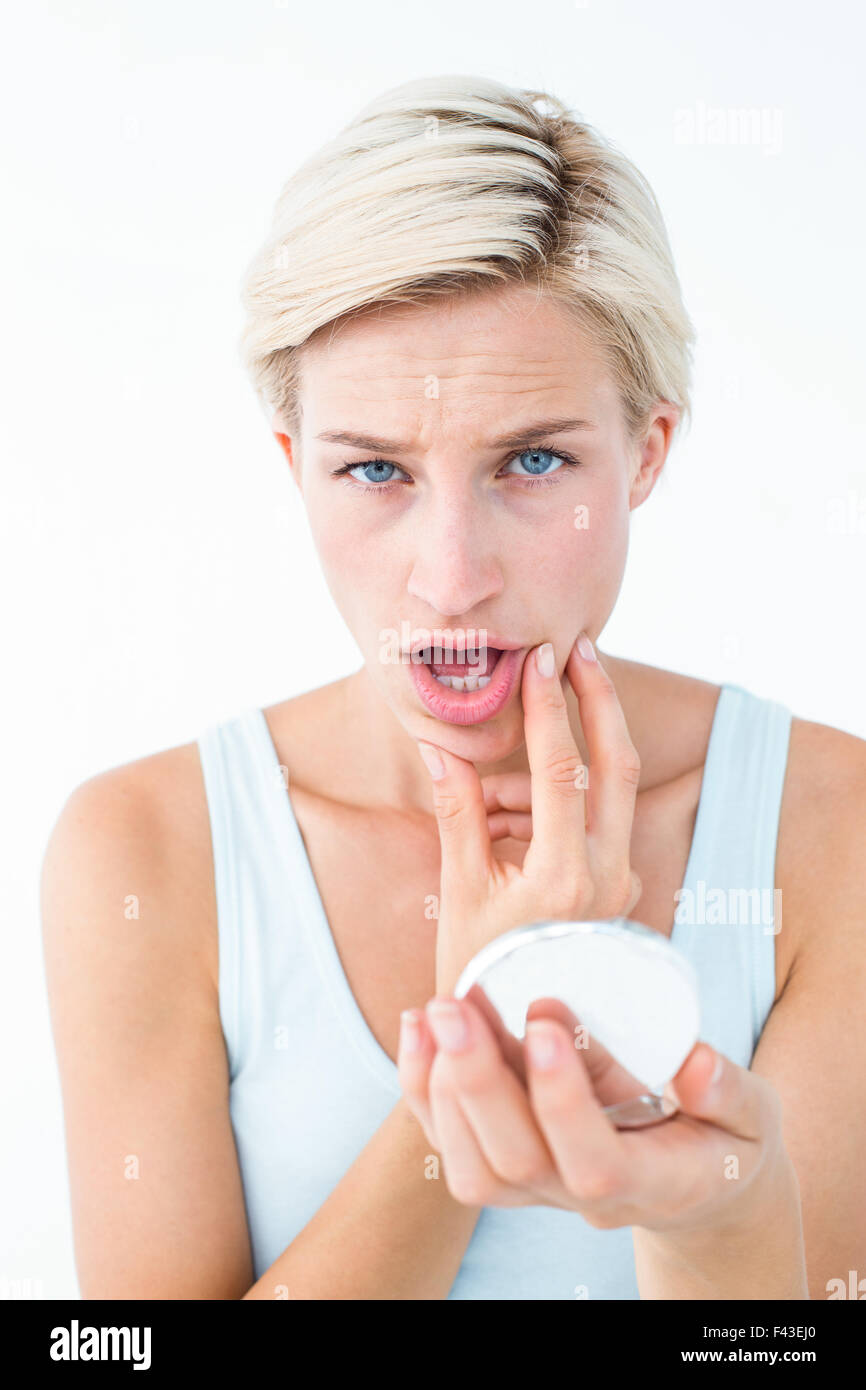 Shocking woman with mirror looking at camera Stock Photo - Alamy