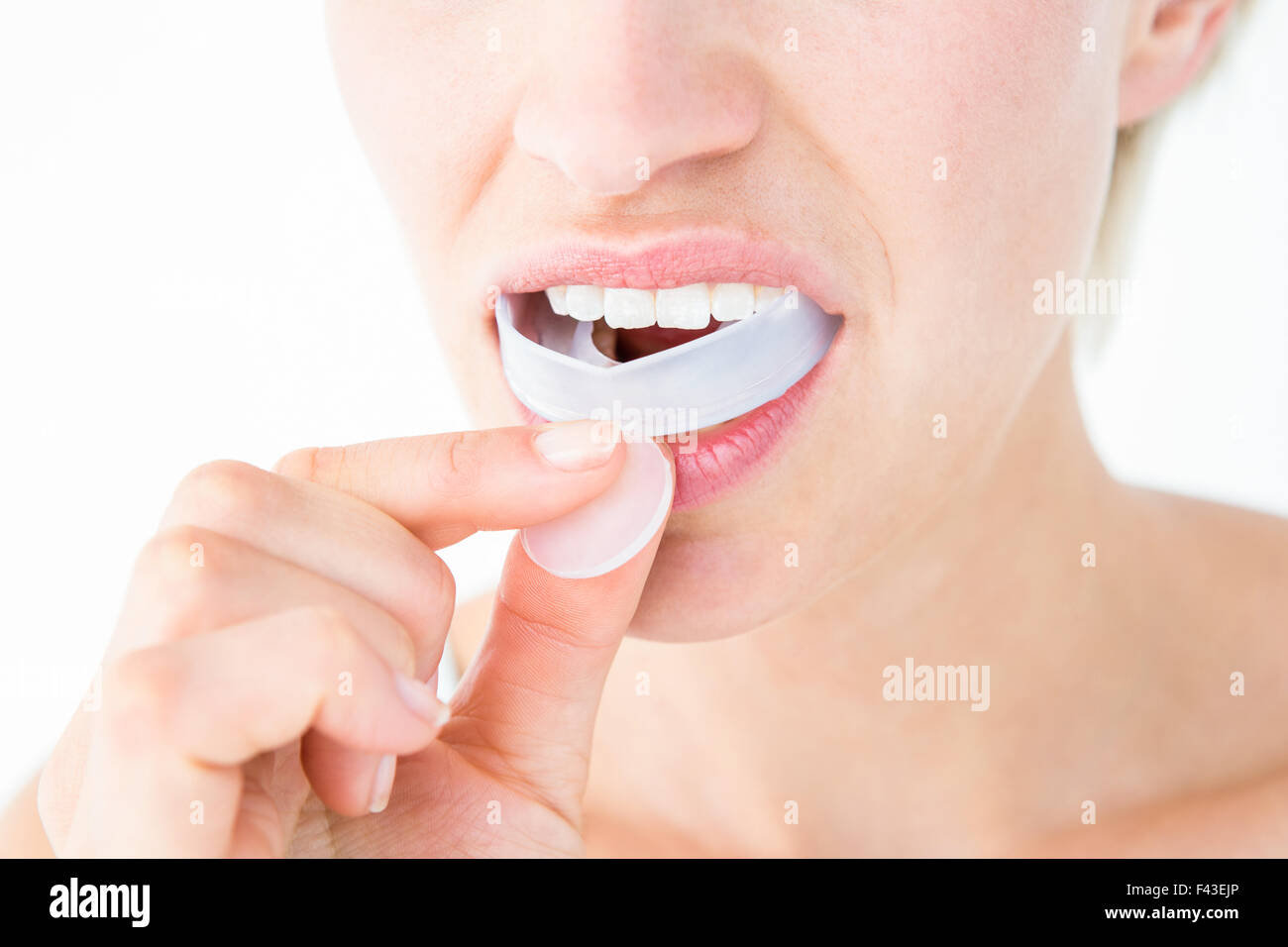 Woman putting her gum shield Stock Photo - Alamy