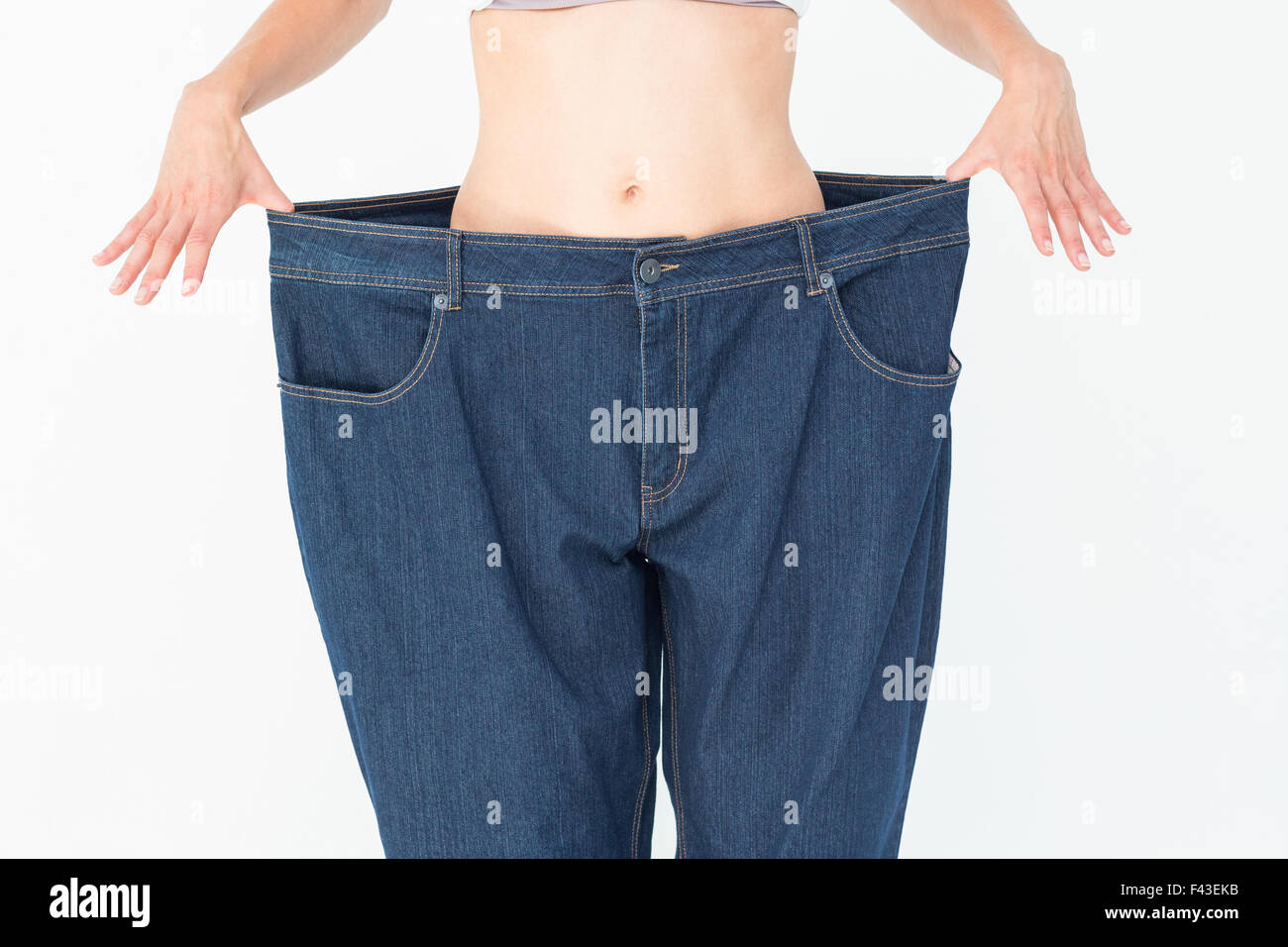 Woman wearing too large pants Stock Photo - Alamy