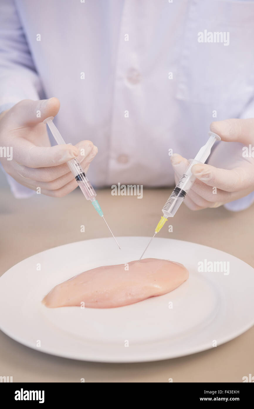 Scientist injecting piece of meat Stock Photo - Alamy