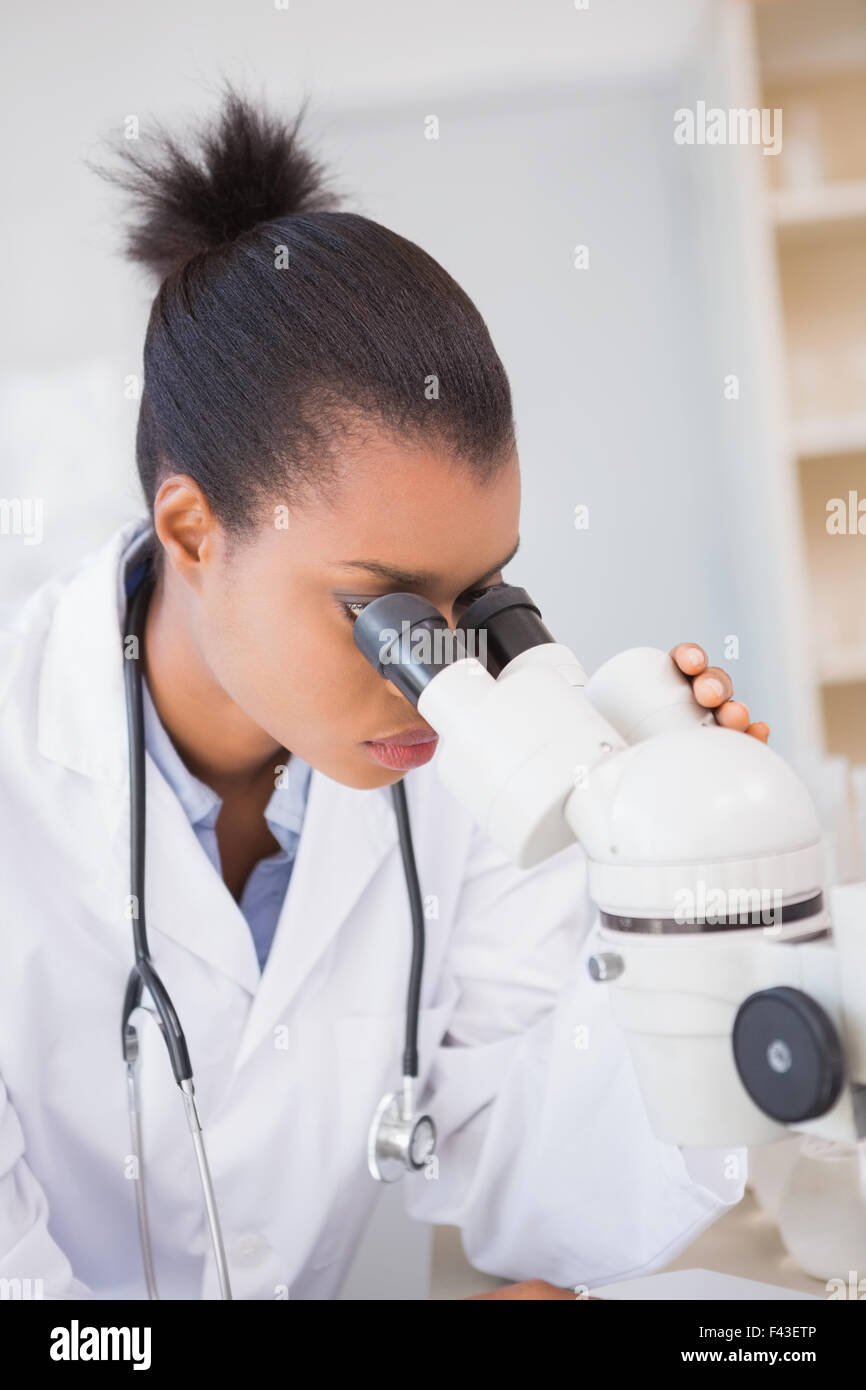 Scientist looking in microscope Stock Photo - Alamy