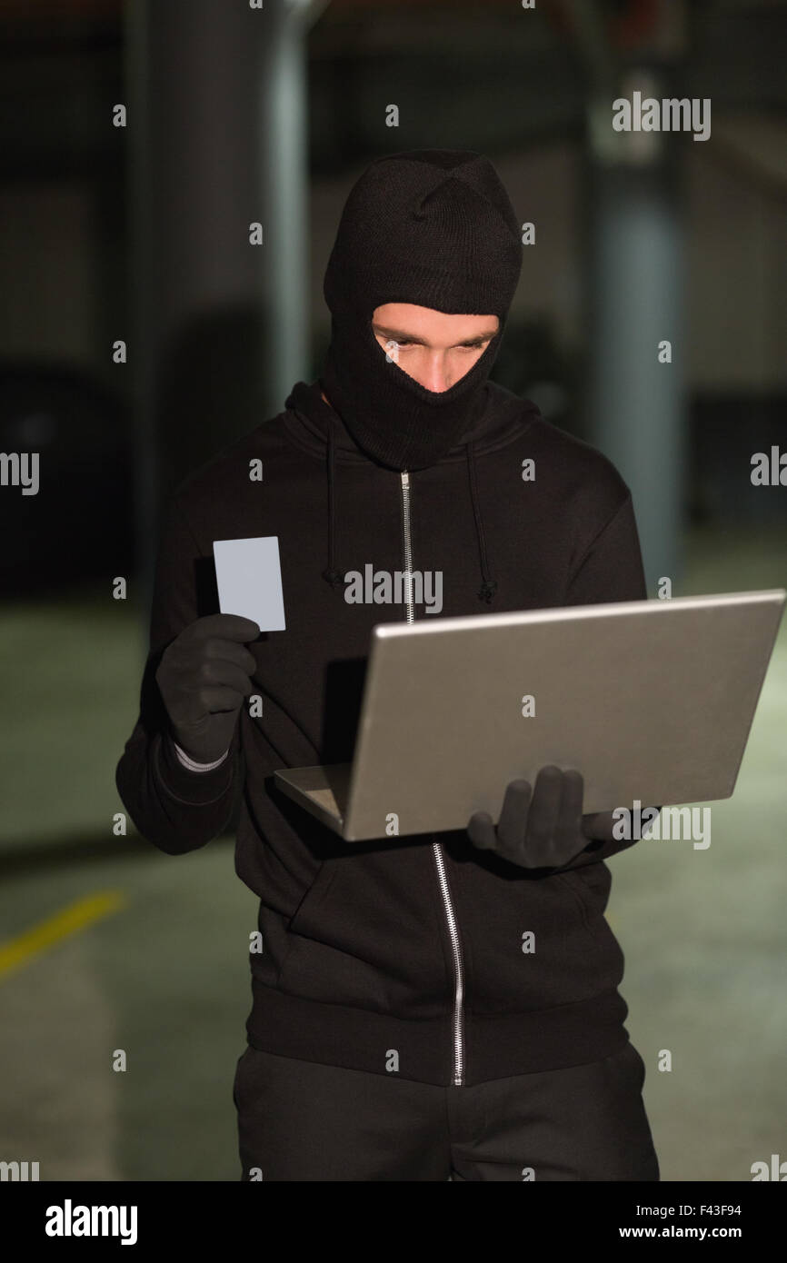 Hacker using laptop to steal identity Stock Photo - Alamy