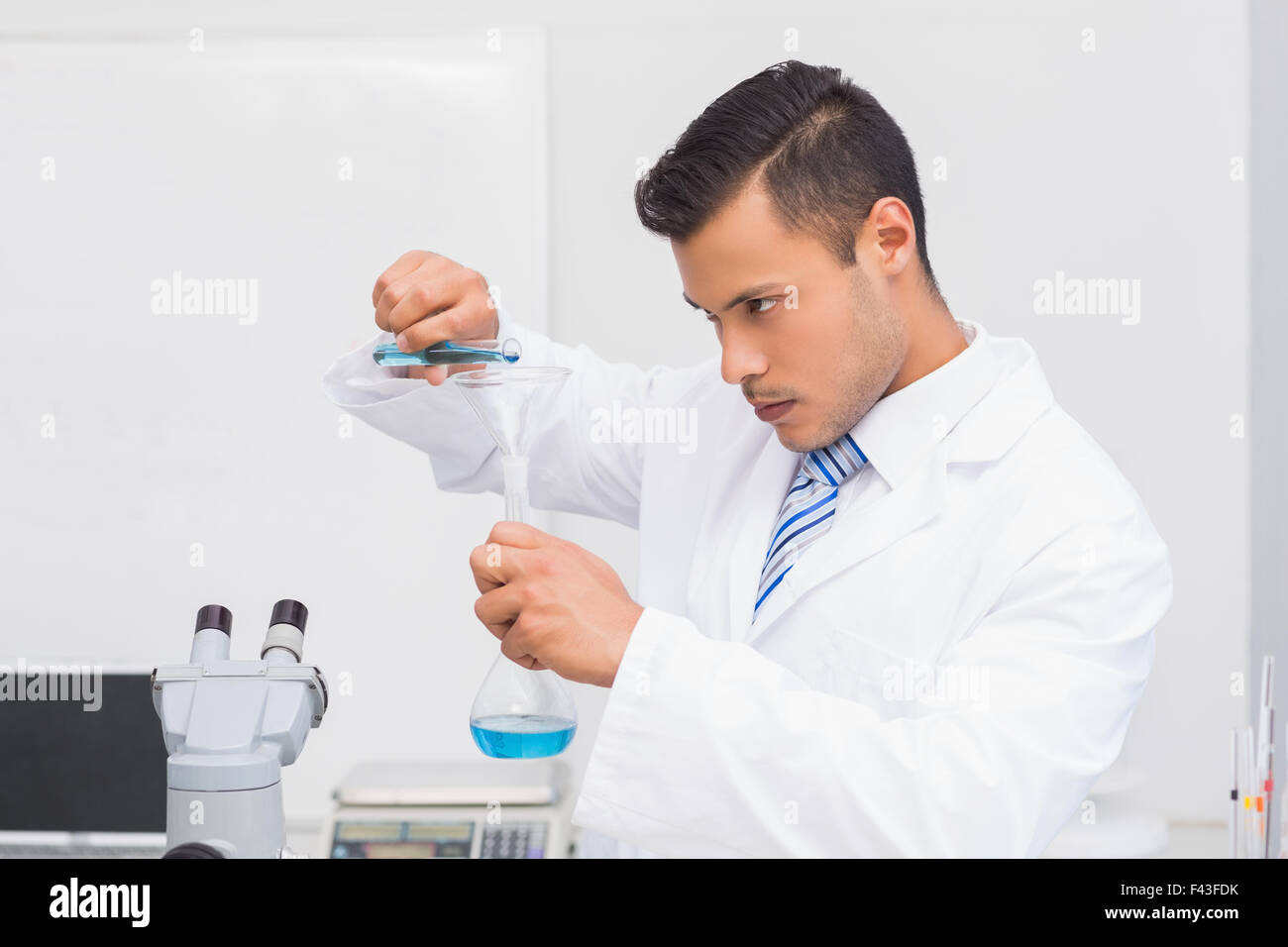 Serious scientist doing tube tests Stock Photo - Alamy