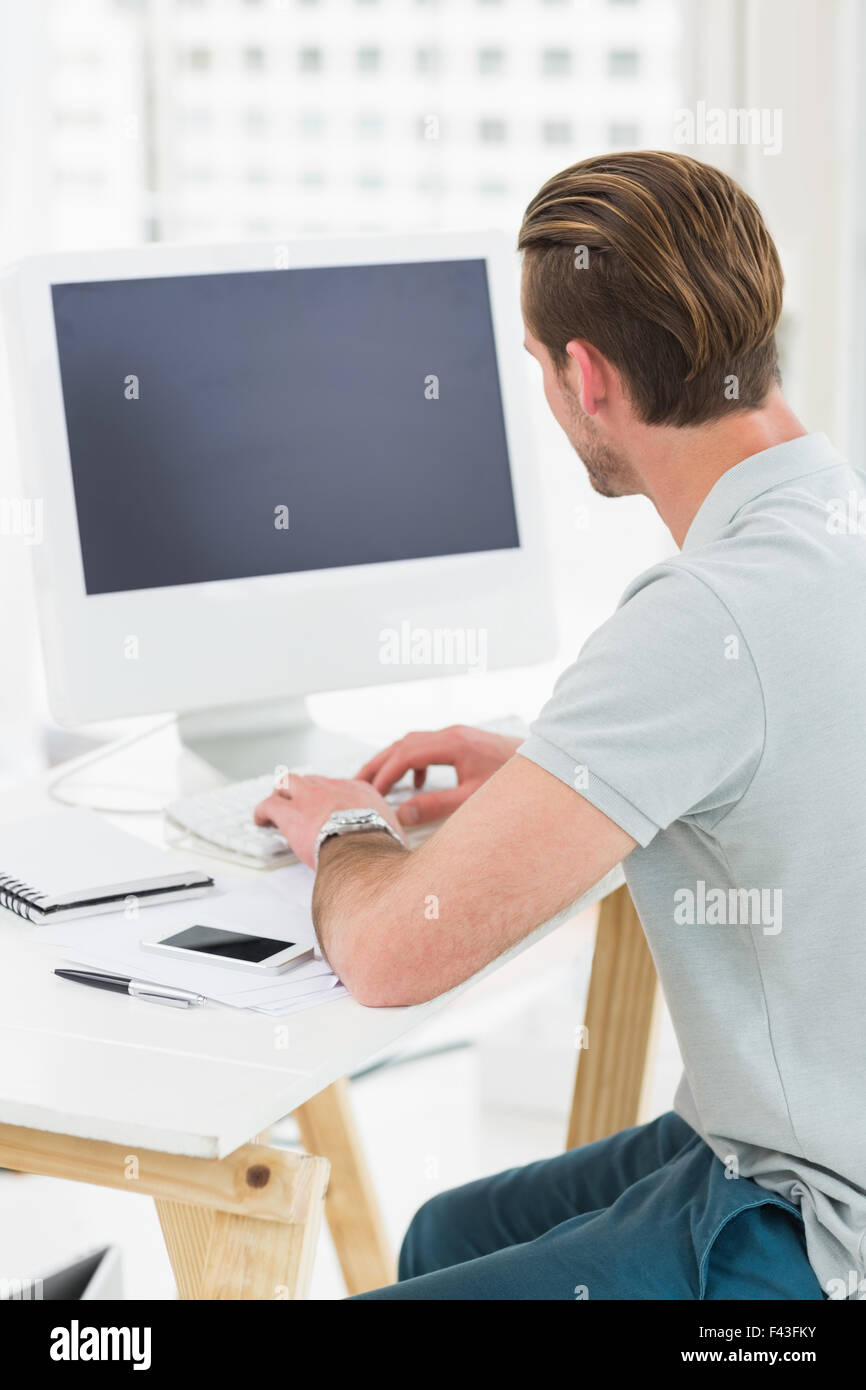 Rear view of businessman typing on keyboard Stock Photo - Alamy