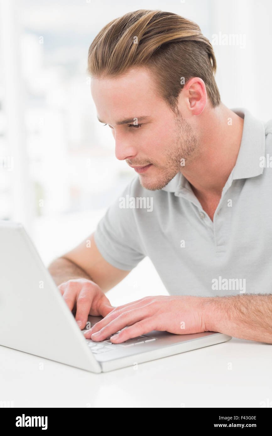Concentrated businessman typing on laptop Stock Photo - Alamy