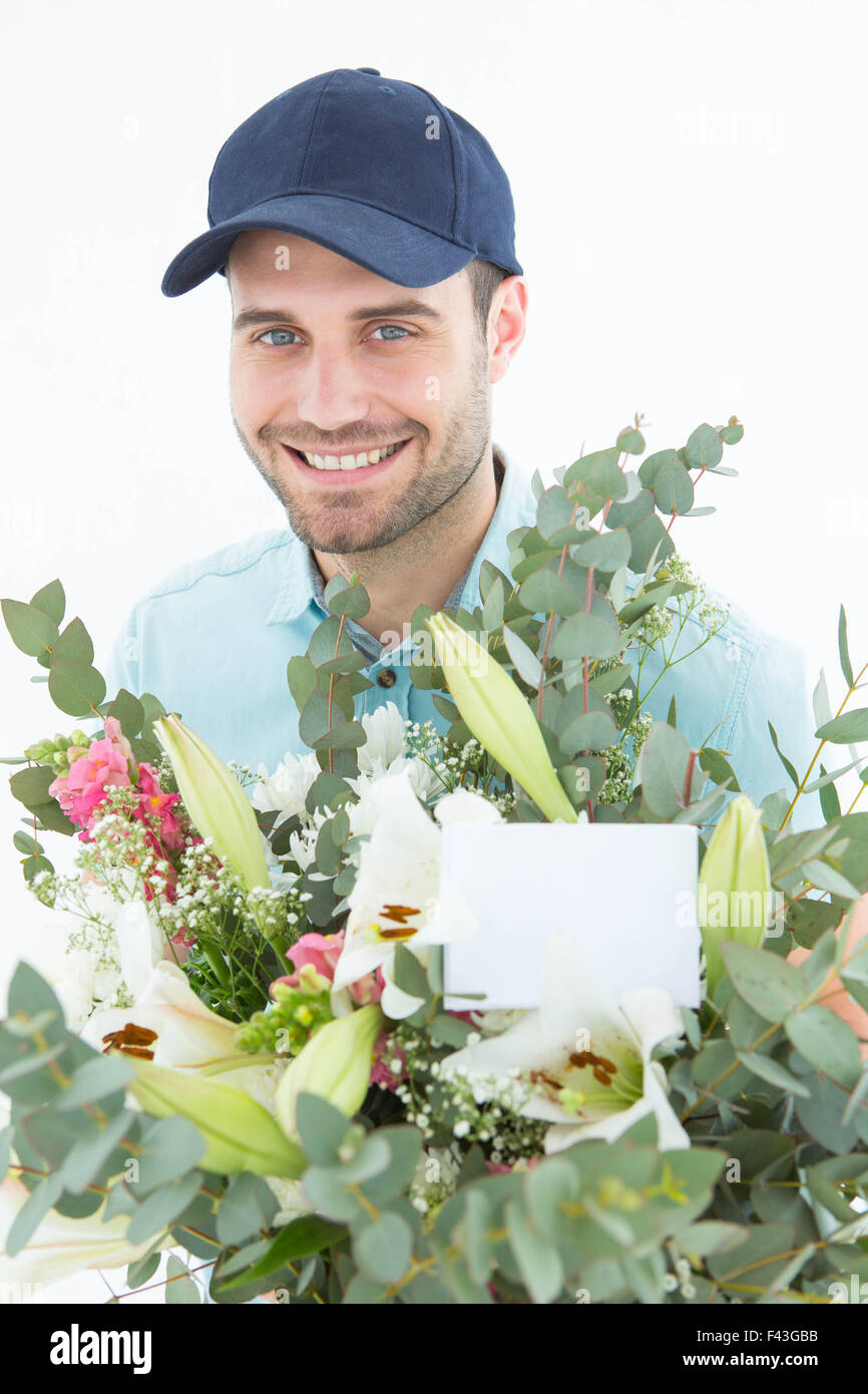 Happy delivery man with bouquet Stock Photo - Alamy