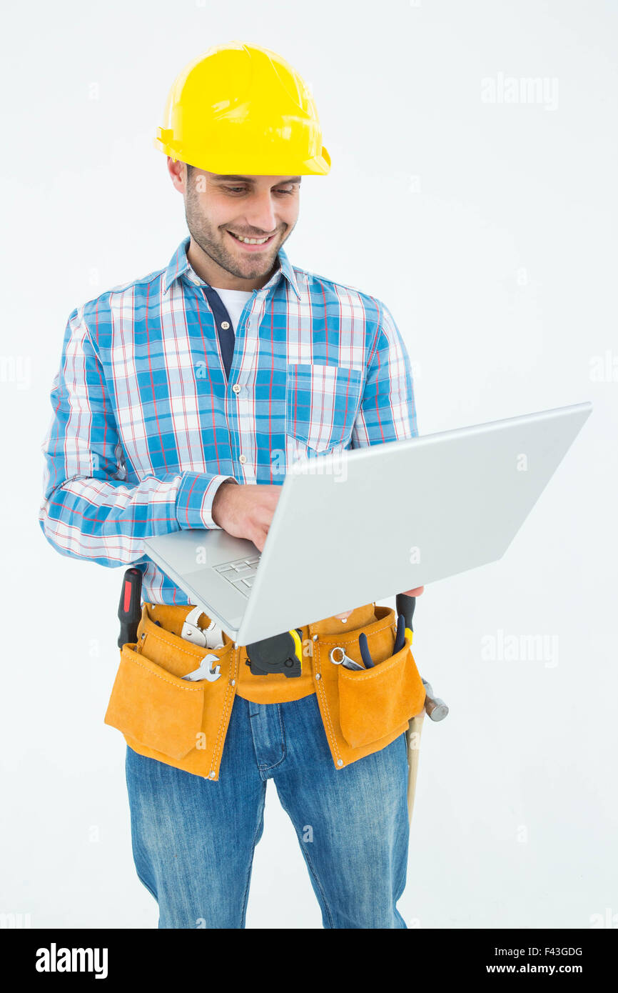 Happy construction worker using laptop Stock Photo - Alamy