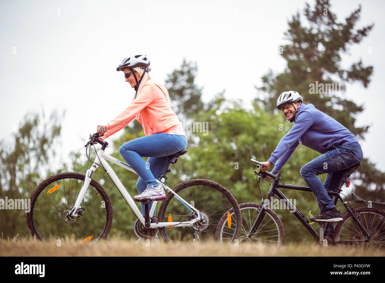 Happy couple on a bike ride Stock Photo - Alamy