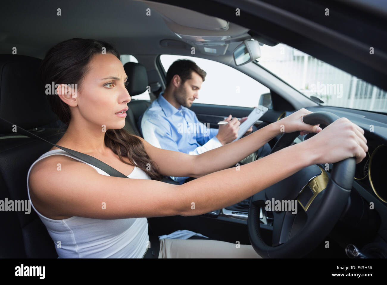 Young woman getting a driving lesson Stock Photo - Alamy