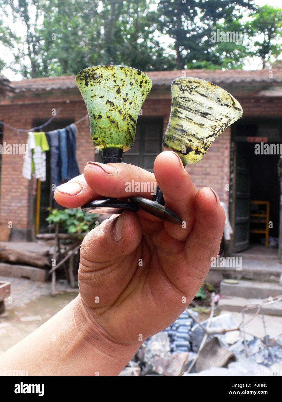 Hand holding carved jade goblets Stock Photo - Alamy