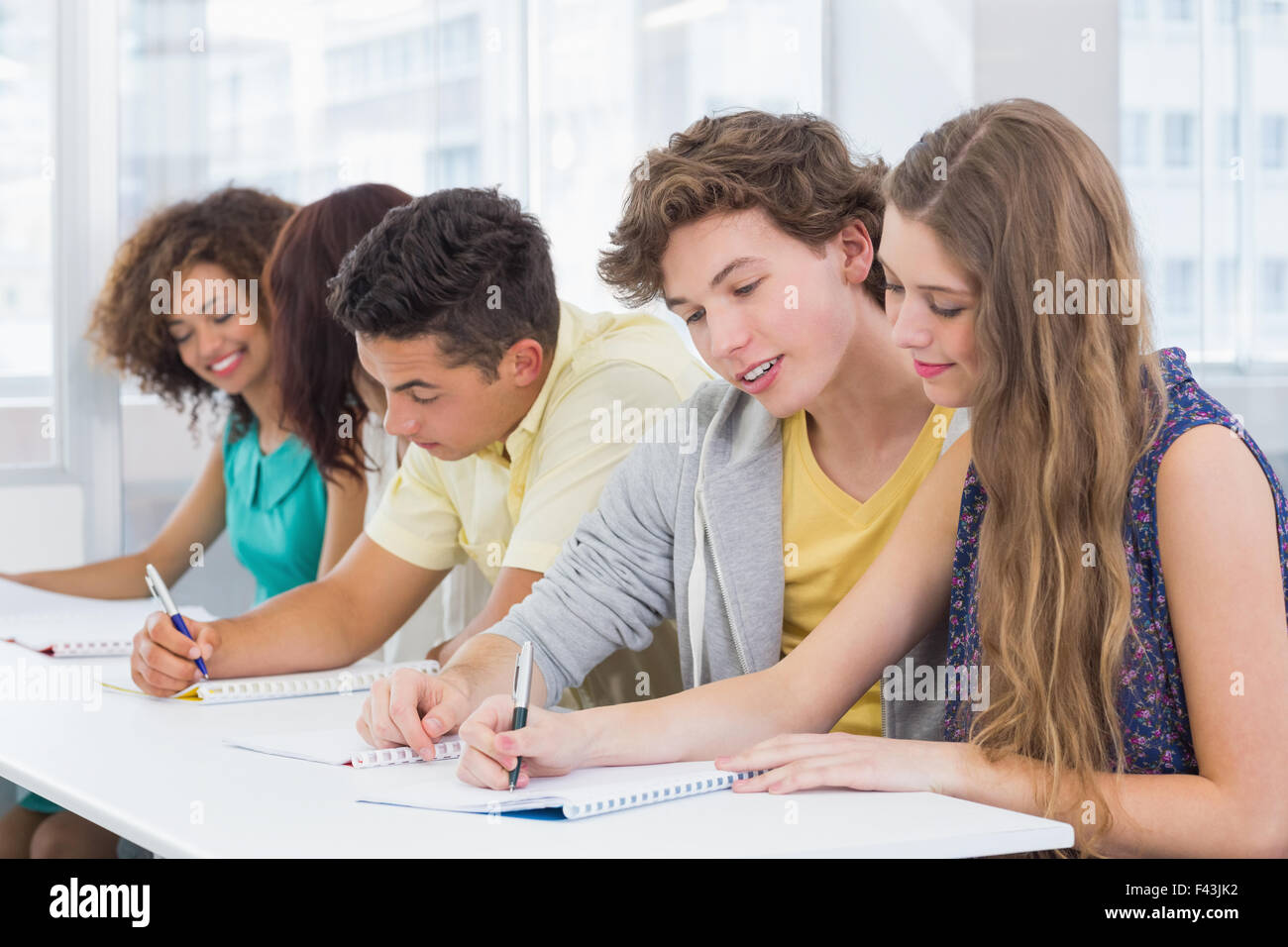 Fashion students taking notes in class Stock Photo - Alamy