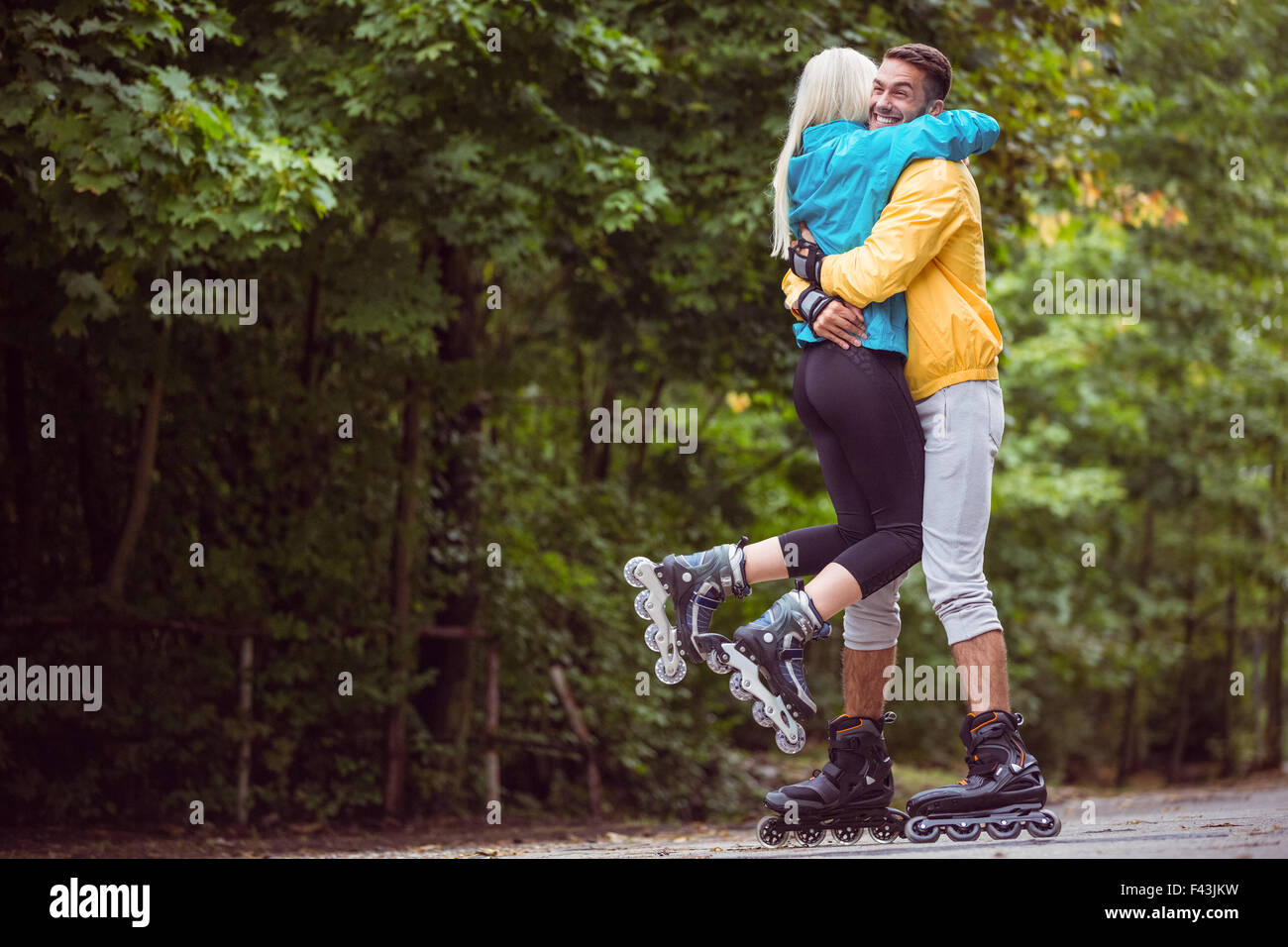 Happy couple roller blading together Stock Photo - Alamy