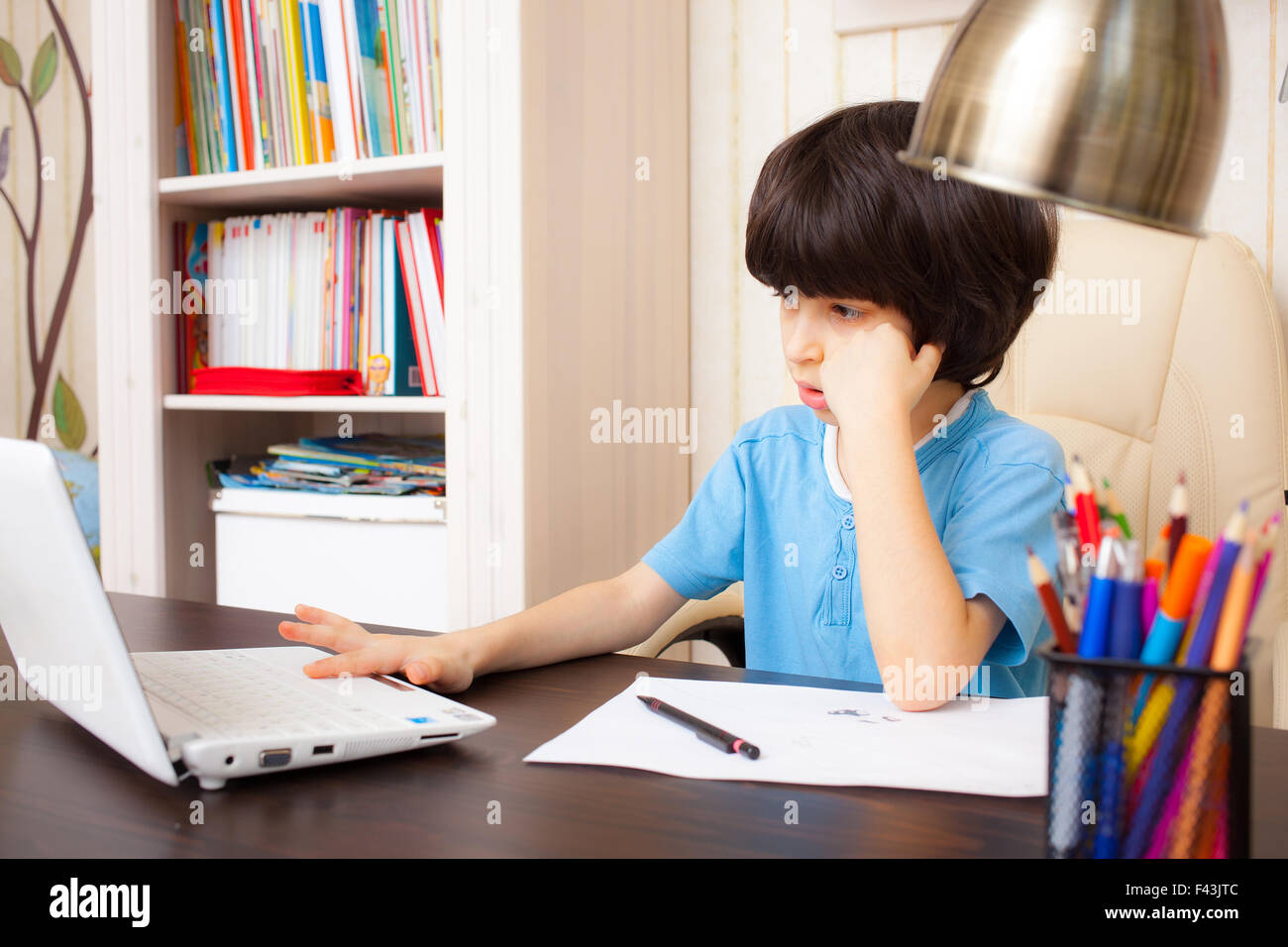 Smiling boy doing homework hi-res stock photography and images - Alamy