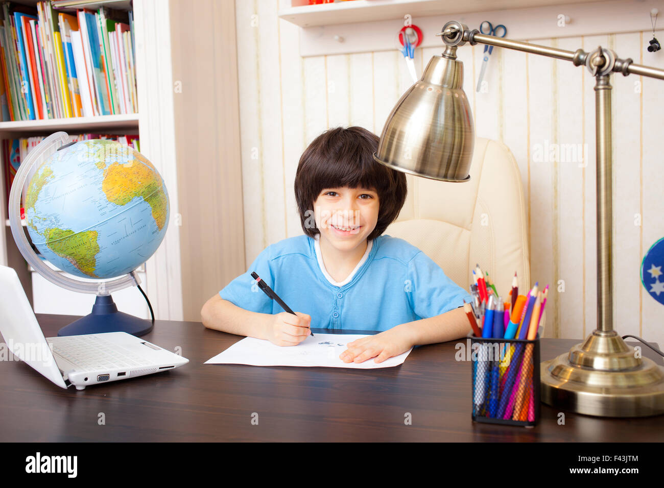 smiling schoolboy doing homework Stock Photo - Alamy
