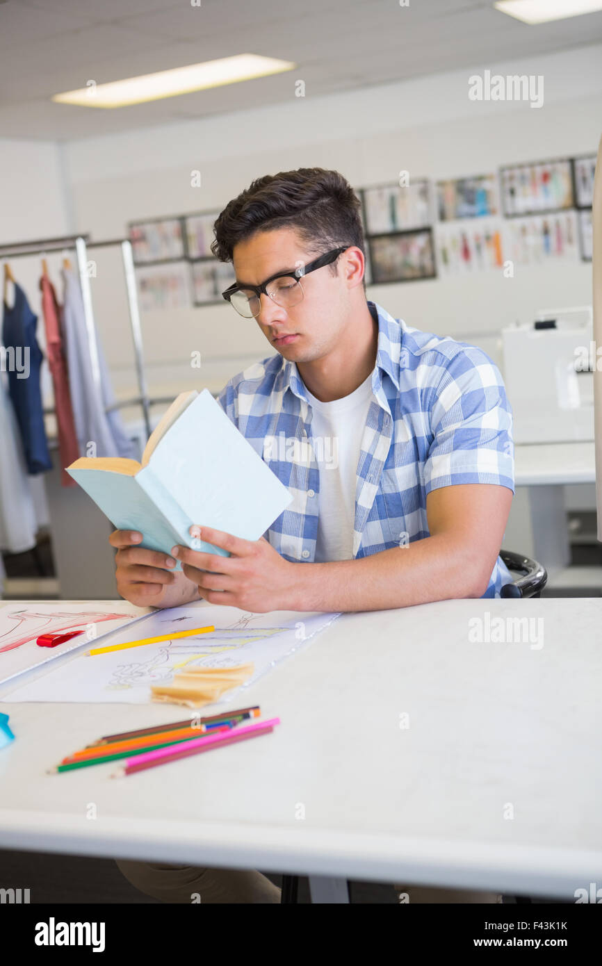 Concentrated college student reading book Stock Photo - Alamy
