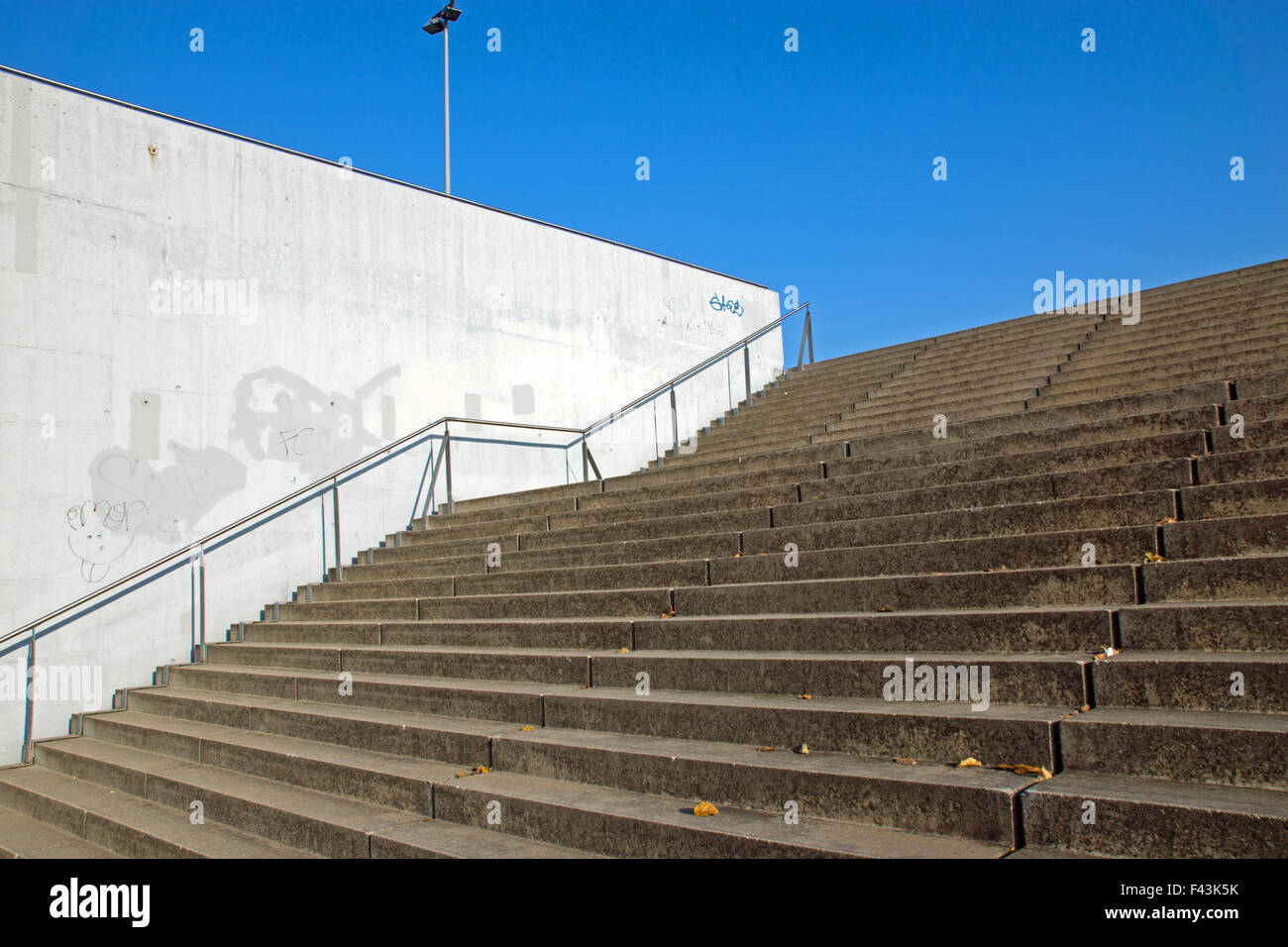 Grey barren stairs in front of a concrete wall Stock Photo - Alamy