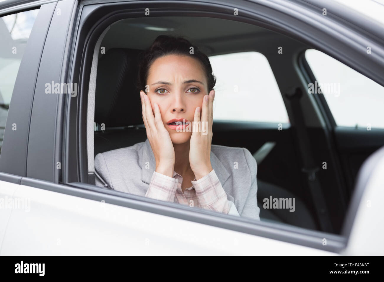 Nervous businesswoman looking at camera Stock Photo - Alamy