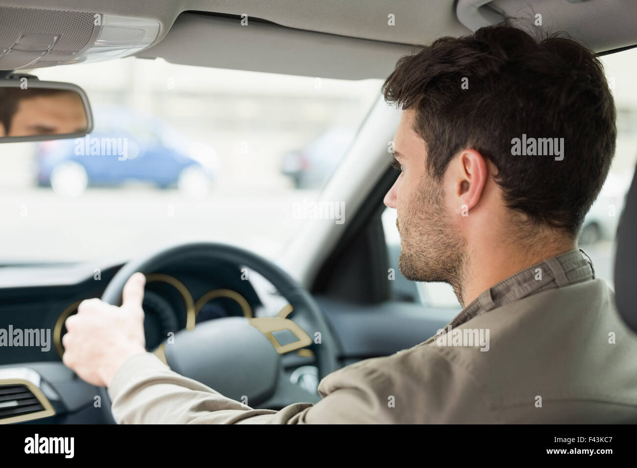 Young man looking ahead while driving Stock Photo - Alamy