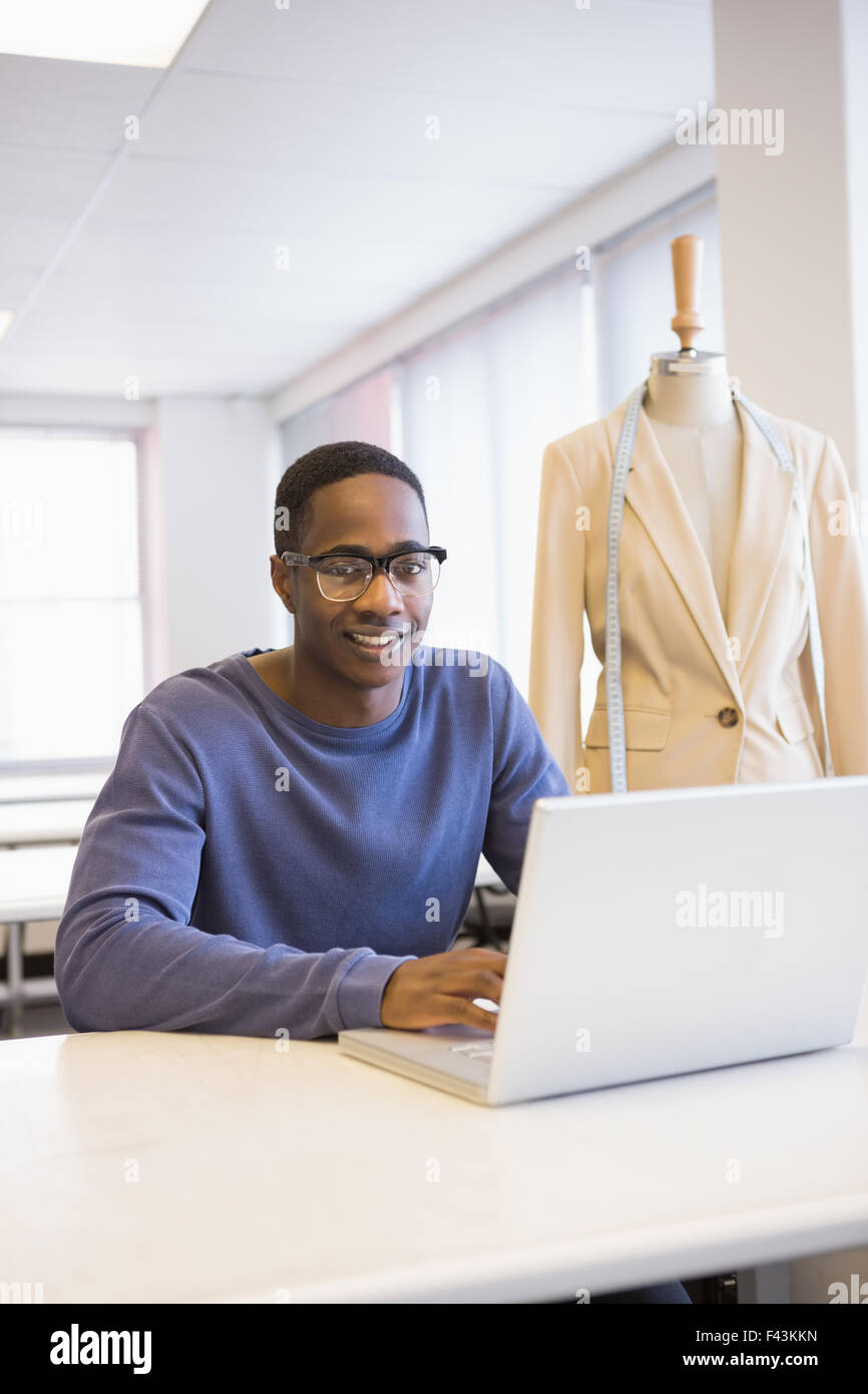 Smiling university student using laptop Stock Photo - Alamy