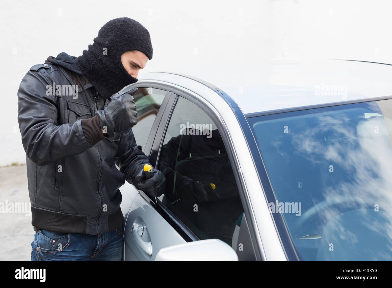 Thief breaking into a car Stock Photo - Alamy