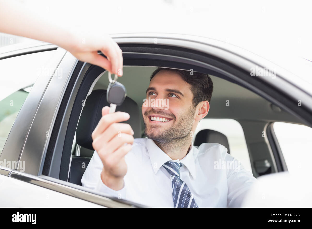 Businessman getting his new car key Stock Photo - Alamy