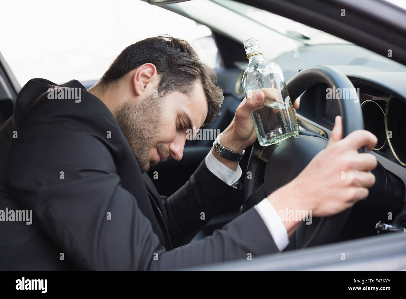 Young businessman driving while drunk Stock Photo - Alamy