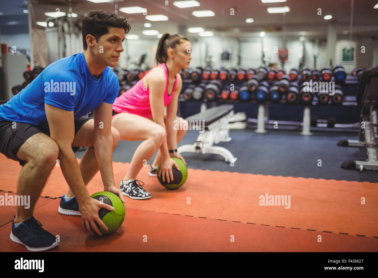 Fit couple working out in weights room Stock Photo - Alamy
