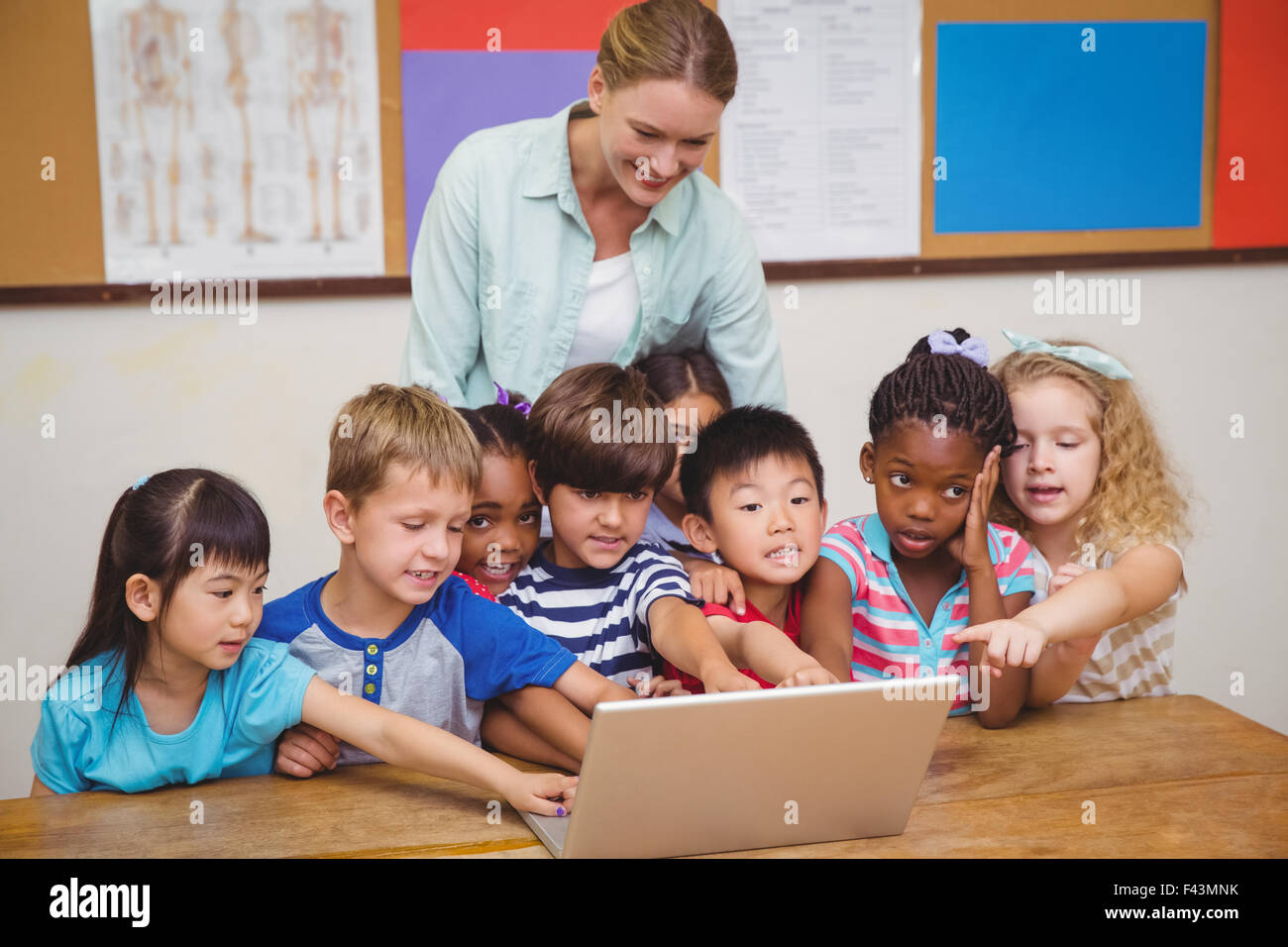 Happy pupils using laptop class hi-res stock photography and images - Alamy