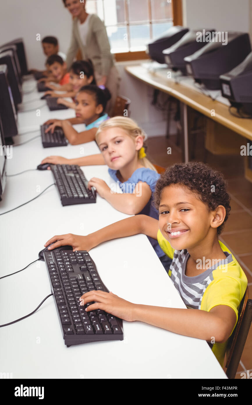 Cute pupils in computer class with teacher Stock Photo - Alamy