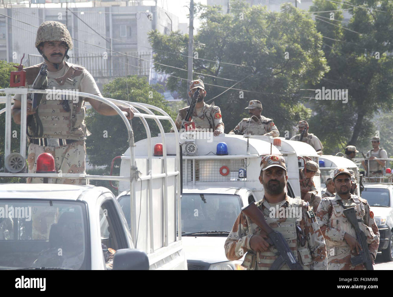 Rangers and Sindh Police staffs are jointly holding a flag march to ...