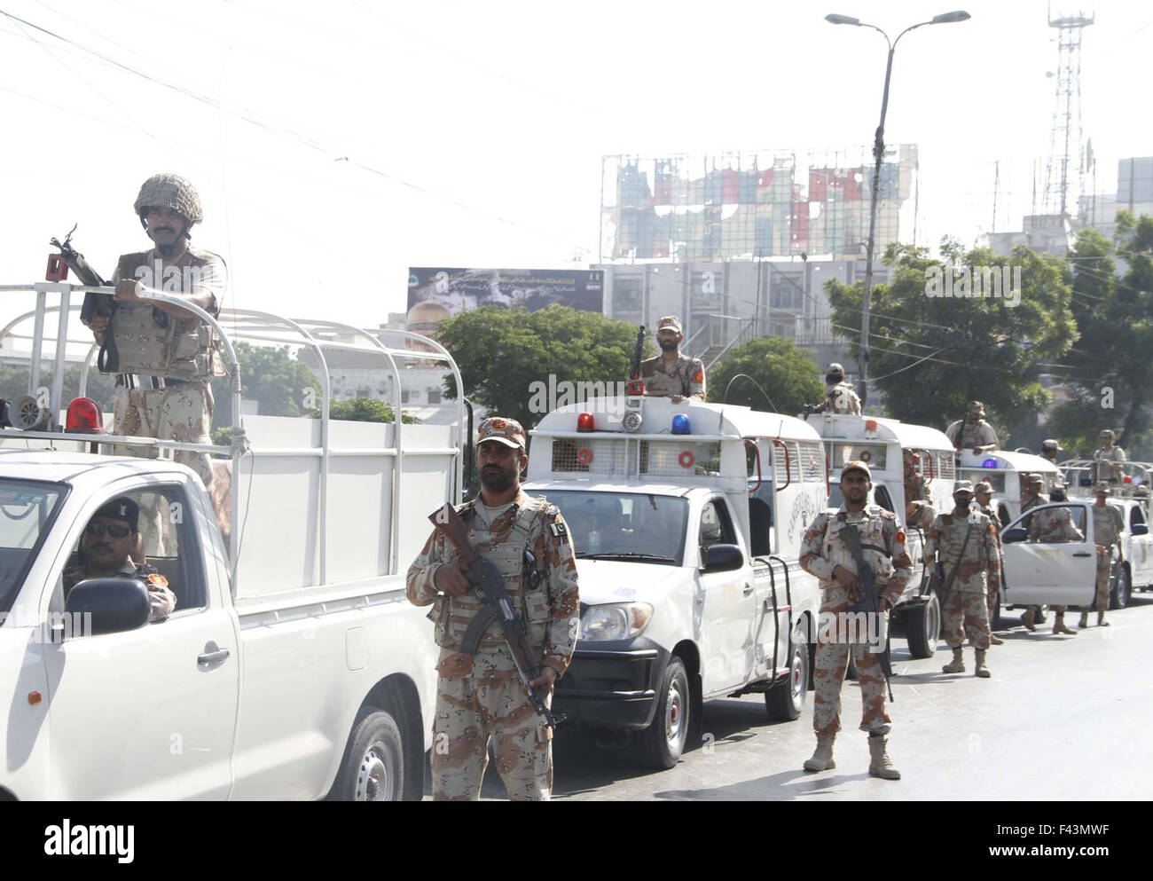 Rangers and Sindh Police staffs are jointly holding a flag march to ...
