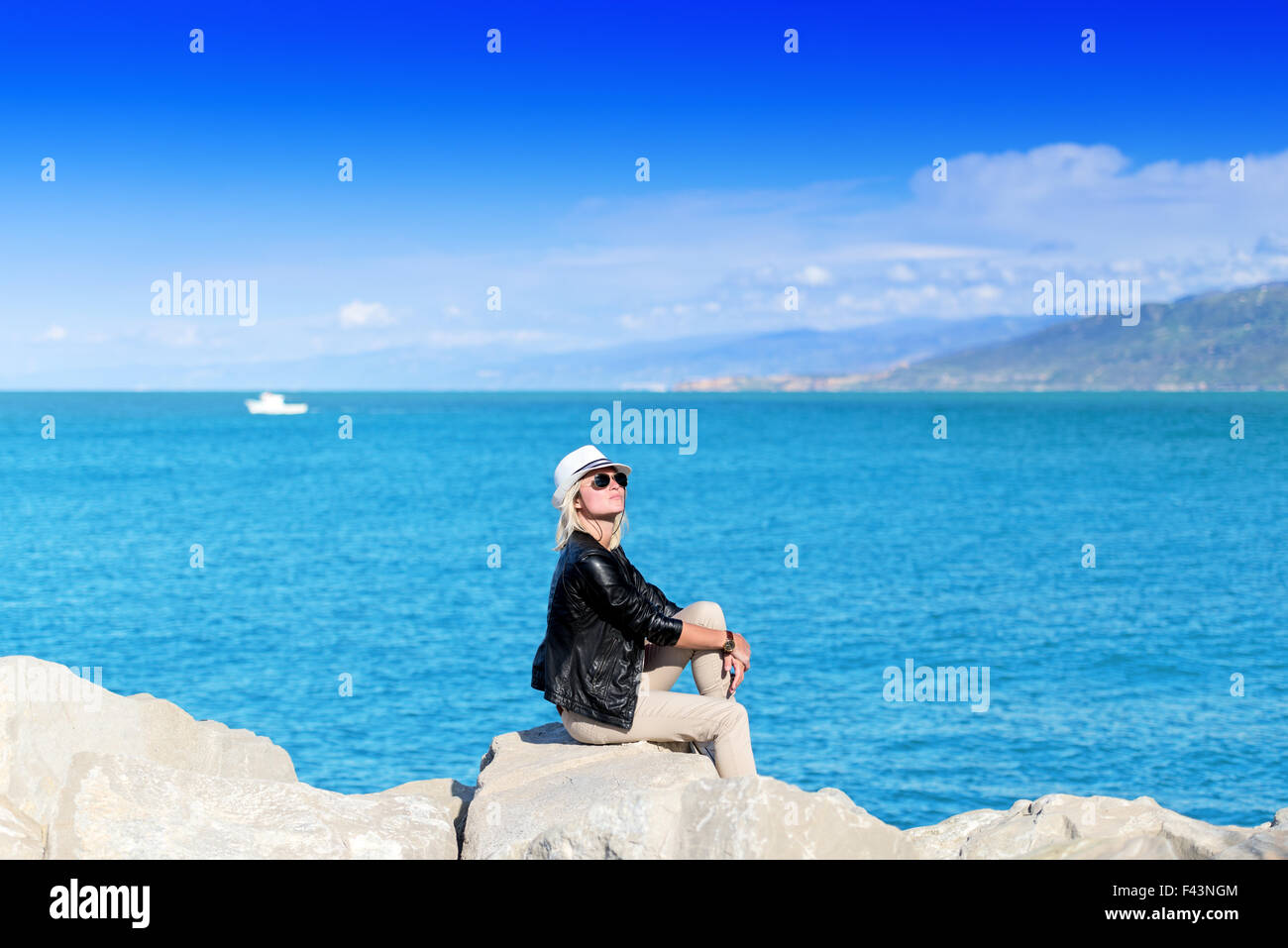 Attractive young woman sunbathing on rocks Stock Photo - Alamy