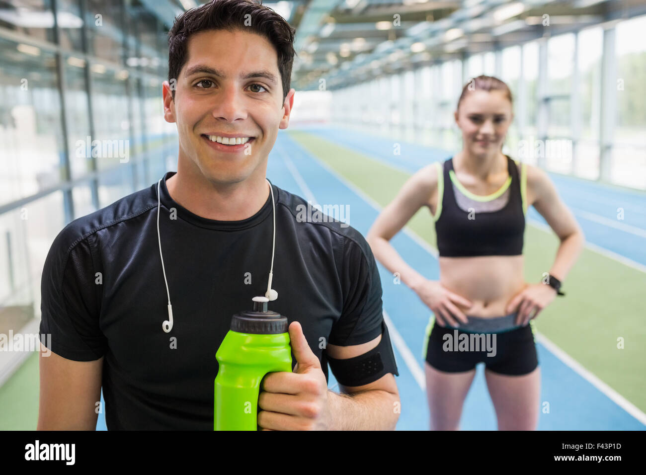 Fit couple on the indoor track Stock Photo - Alamy