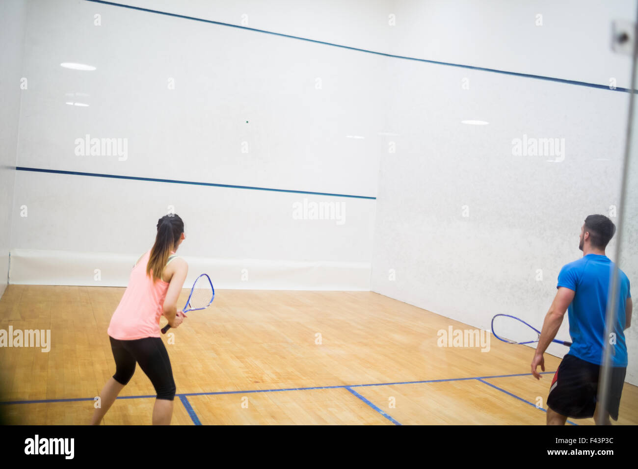 Couple enjoying a game of squash Stock Photo - Alamy