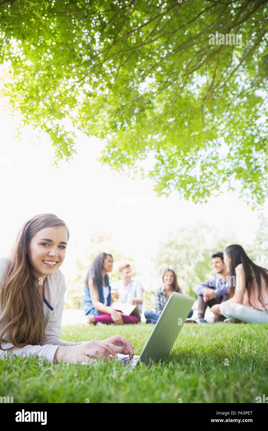 Happy student using her laptop outside Stock Photo - Alamy