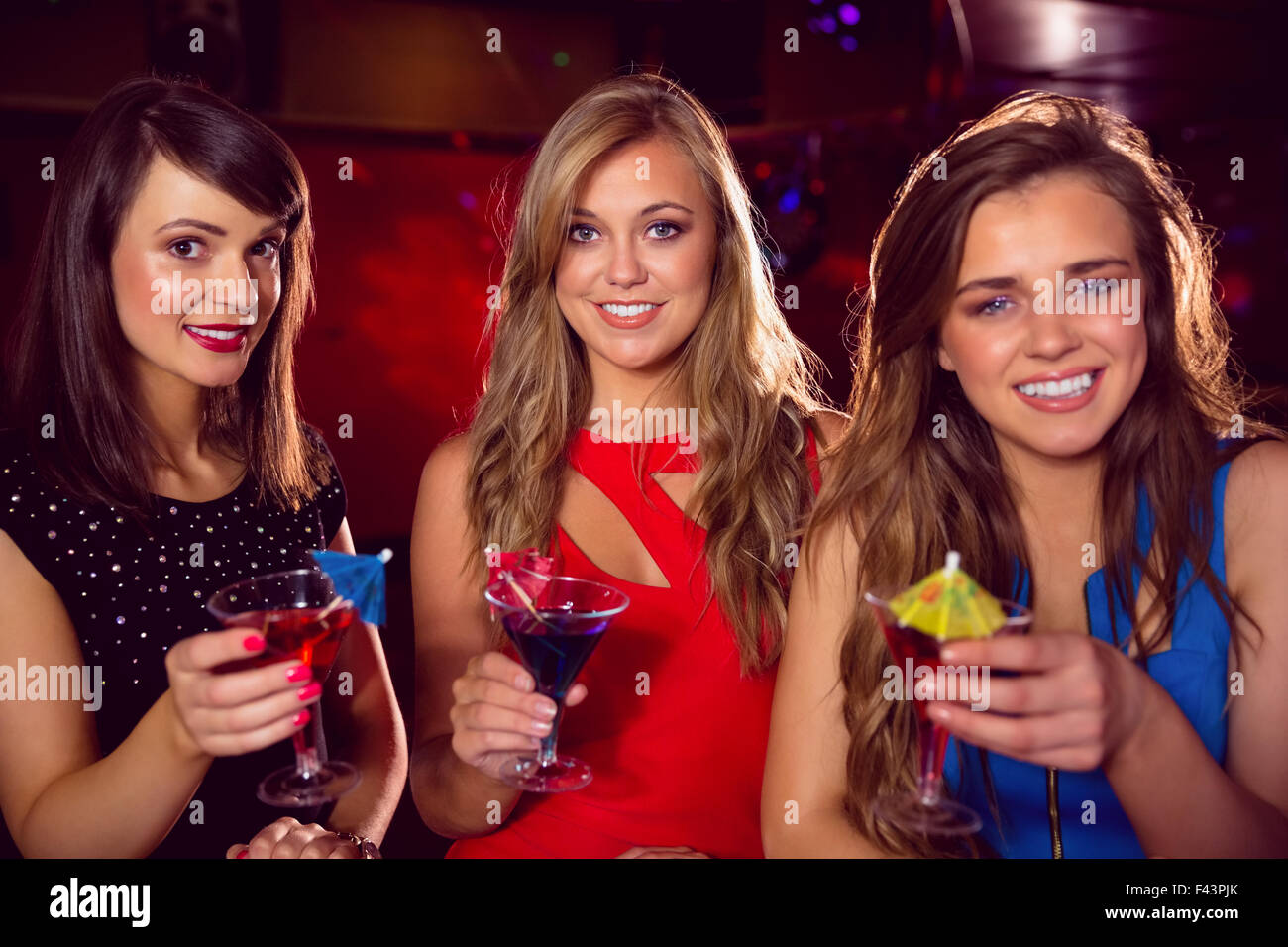 Pretty friends drinking cocktails together Stock Photo - Alamy