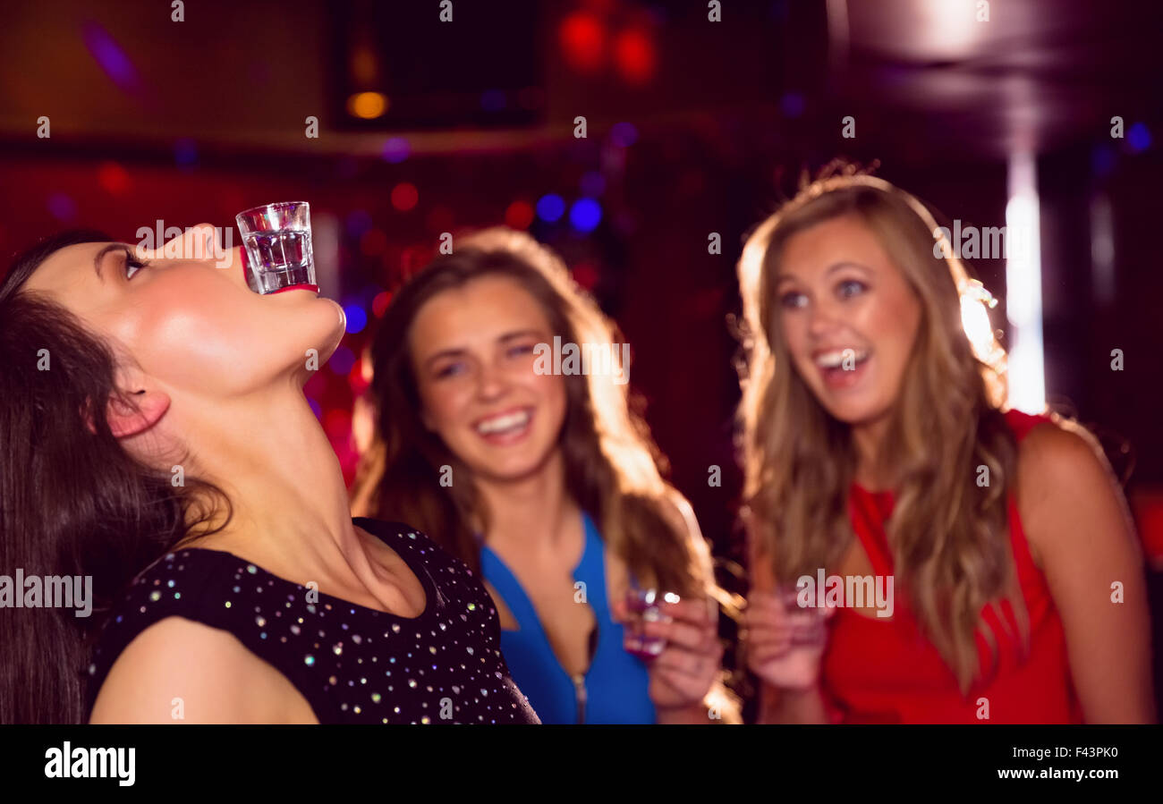 Pretty friends drinking shots together Stock Photo - Alamy